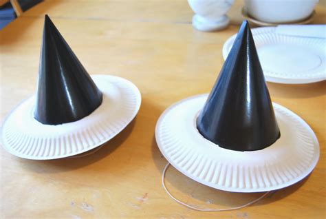 A Babe Learning For Two Paper Plate Witches Hats