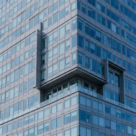 Modern High Rise Building With A Glass Facade Featuring Large