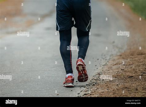 Feet Man Running Down Road In Woods During A Marathon Stock Photo Alamy