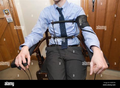 Man Being Examined Using A Polygraph Test Lie Detector Machine Which Compares Responses To