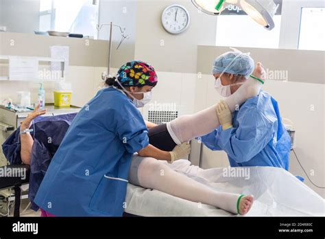 Nurse Fitting A Deep Vein Thrombosis Dvt Prevention System To The Lower Legs Of A Patient