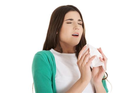 Premium Photo Young Woman Sneezing Against White Background