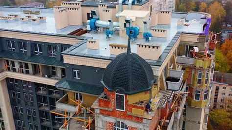 Construction Of Modern Tower House Workers Build The On The Top Of