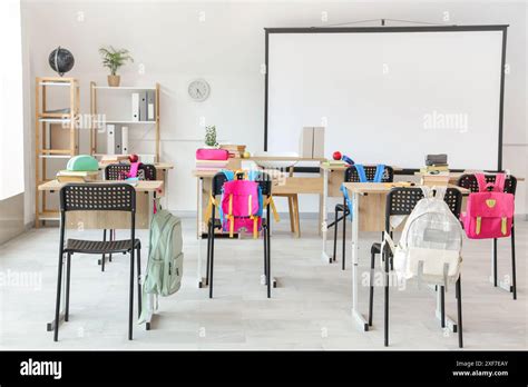 Interior Of Light Classroom With Projector Screen And Desks Stock Photo Alamy