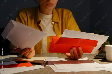 Crop Female Sorting Mail At Night Stock Photo Adobe Stock