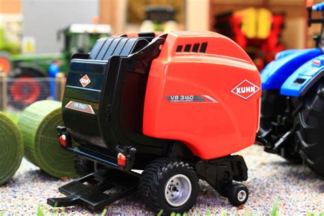 43233 Britains Kuhn Vb 3160 Round Baler With 2 Round Bales Brushwood Toys