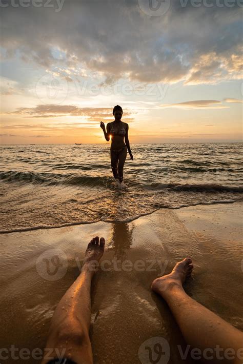 Woman Silhouette On The Beach At Sunset With Man Legs 12502422 Stock