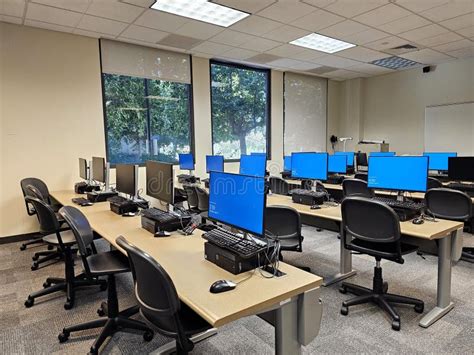 Modern Classroom With Computer Monitors Situated On Desks Stock Image