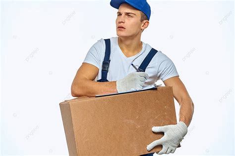 A Worker Holding A Box For Delivery On A Light Background In A Loading Service Job Photo And