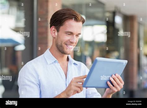 A Happy Smiling Man Using His Tablet Stock Photo Alamy