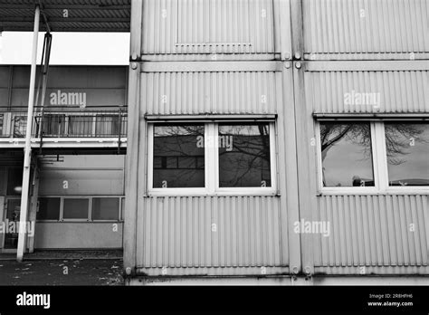 This Two Story Structure Features Expansive Windows And Staircases On Each Level Giving It A