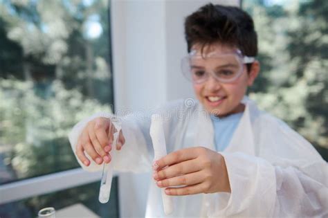 Close Up Hands Of A Blurred Teen Nerd Babebabe Chemist Scientist Holding Test Tubes With