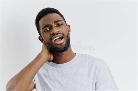 Contemplative Young Man With Hand On Head Gazing Upward With An Introspective Expression Stock