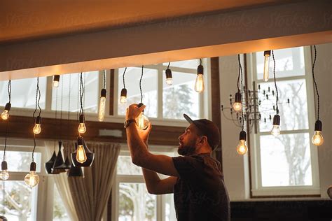 Man Putting Retro Light Bulb By Stocksy Contributor Pietro Karras Stocksy