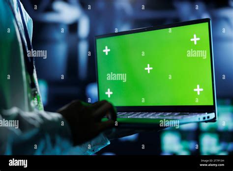 dara center system administrator running code and programming on chrome key laptop