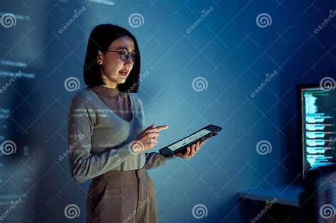 Asian Woman Programmer Standing In Front Of A Screen With Code