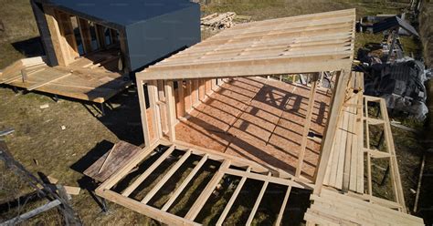 산에서 건설 중인 말뚝 기초 위에 있는 목조 프레임 하우스의 조감도 사진 Unsplash의 건설 현장 이미지