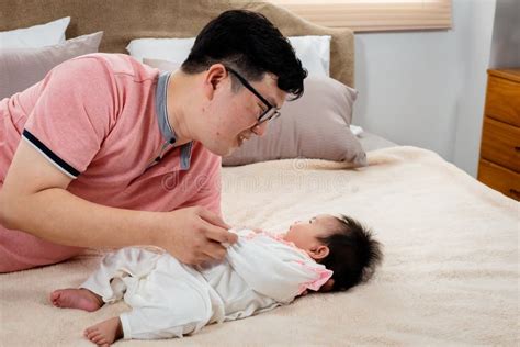 Handsome Asian Father Wearing Pink Shirt Lying And Teasing With His