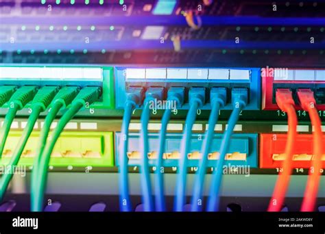 Server Rack With Blue And Red Internet Patch Cord Cables Connected To Black Patch Panel In Data
