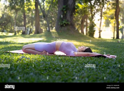 Attractive Young Asian Woman Practice Yoga Exercise In The Park
