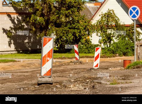 Red And White Striped Traffic Control Devices For Avoiding Sections Of The Road Being Repaired