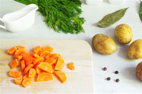 생선 수프를 준비하기위한 재료 당근은 야채 칼이달린 나무 도마에 반조각으로 자른다 로히키티토는 핀란드 전통 수프이자 카렐리안 수프입니다 0명에 대한 스톡 사진 및 기타