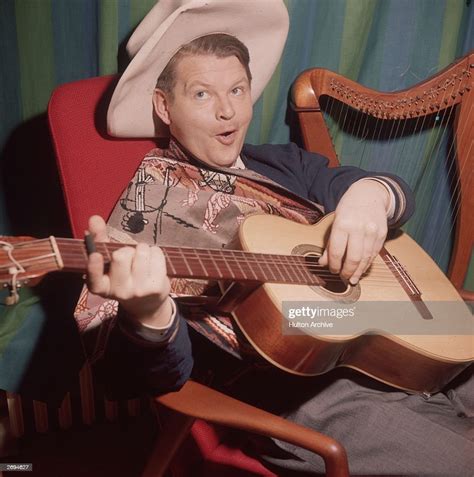 British Comedian Benny Hill Contrives To Play The Guitar In A News