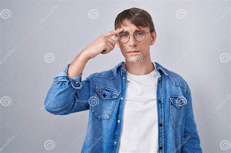 Caucasian Blond Man Standing Wearing Glasses Pointing Unhappy To Pimple