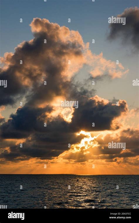 The German Wadden Sea At High Tide During Sundown The Sunlight Is Casting Light Rays Through