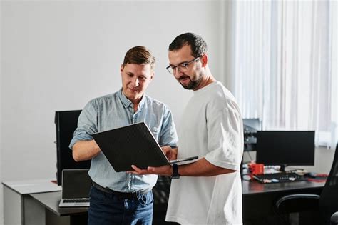 Premium Photo Portrait Of Two Professional Male Programmers Working On Computer In Diverse