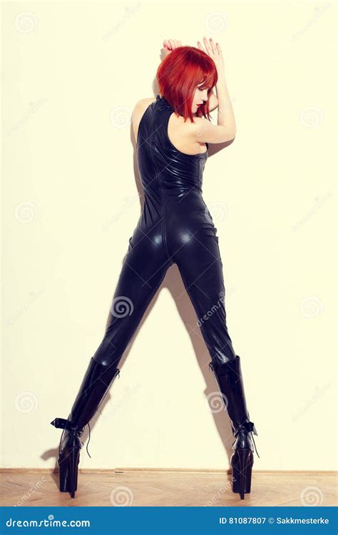 Redhead Dominatrix Woman In Latex Catsuit Posing At Wall Stock Image Image Of Erotic