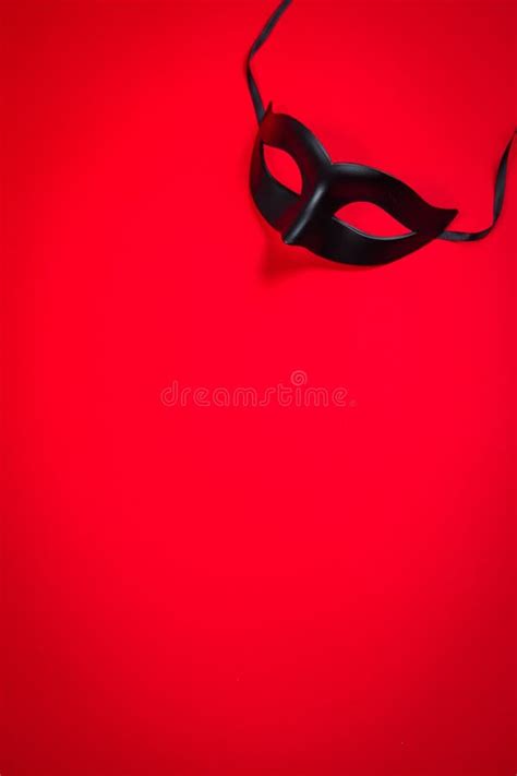 Black Mask On A Redstudio Paper Background Stock Image Image Of Modern Party 165301501