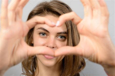 Romantic Woman Making A Heart Gesture With Her Hands Framing Her