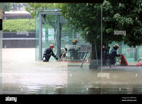 Workers Try To Protect The Entrance Of A Subway Station From Flooding After Hours Of Downpours