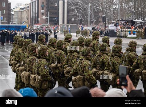 A Platoon Of Estonian Soldiers Marching In The Line Dressed In