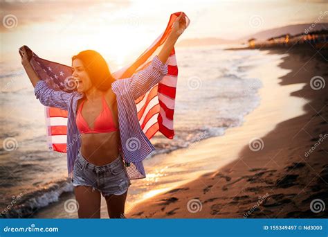 Happy Woman Running On Beach While Celebrateing Independence Day And