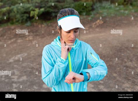 Woman Checking Pulse Rate On Smart Watch Stock Photo Alamy
