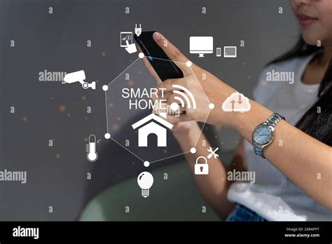 Womans Hands Holding Smartphone In Bedroom With Couple Exposure Of Smart Home Interface