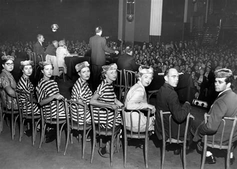 Women Dressed In Prison Uniforms Sitting On Stage In Front Flickr