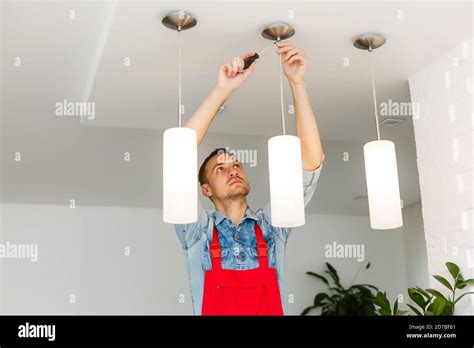 Electrician Man Worker Installing Ceiling Lamp Stock Photo Alamy