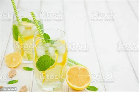 레몬 슬라이스 민트와 갈색 설탕 흰색 나무 배경에 얼음 유리에 수제 레모네이드 수평 방향 공간을 복사합니다 0명에 대한 스톡