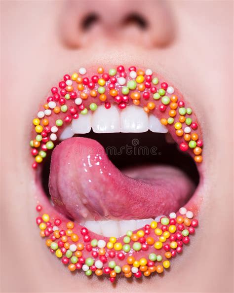 Closeup On Female Sweet Candy Lips With Licking Tongue Stock Image