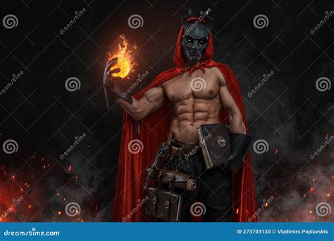 Muscular Wizard With Naked Torso And Fireball Against Fog Stock Photo