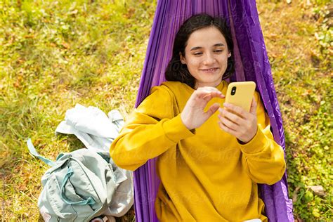 Happy Girl Swiping Phone By Stocksy Contributor Demetr White Stocksy