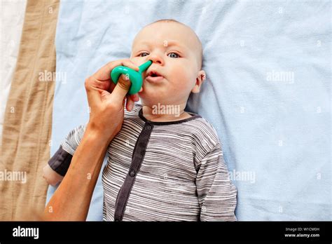 Mother Cleaning Nose Of Cute Baby Stock Photo Alamy
