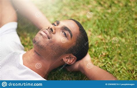 Relax Chill Out And Unwind A Young Man Relaxing On The Grass Outdoors