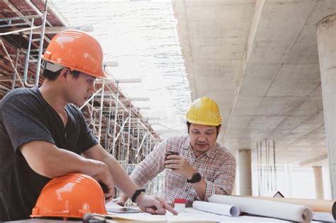 Construction Concept Of Engineer And Architect Working With Construction Model And Blueprint At