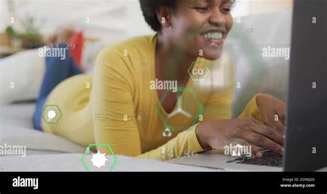 Image Of Media Icons And Data Processing Over Biracial Woman Using
