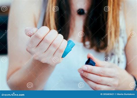 Woman Using An Asthma Inhaler Indoors Using Medication During An Asthma Attack Stock Image