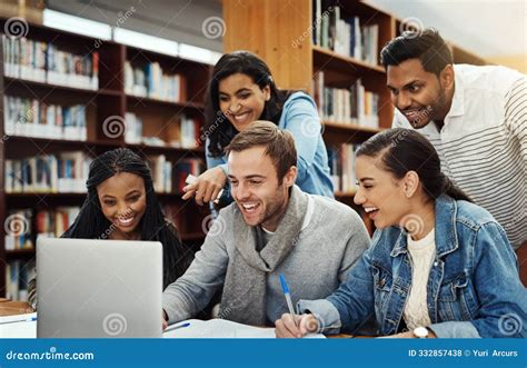 University Students And Laughing At Laptop In Library For Research